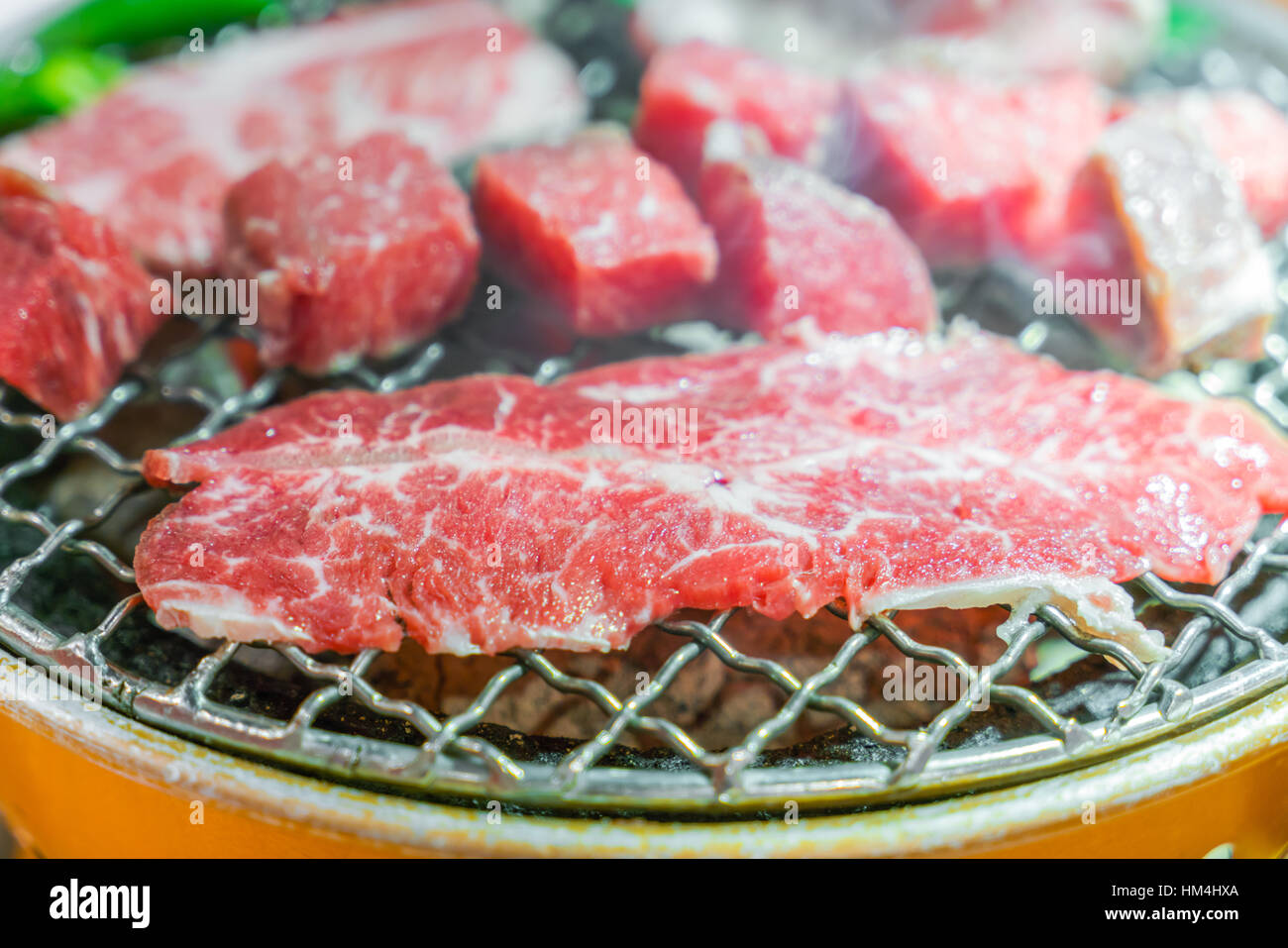 Japanese style Raw fresh beef on hot barbecue grill Stock Photo - Alamy