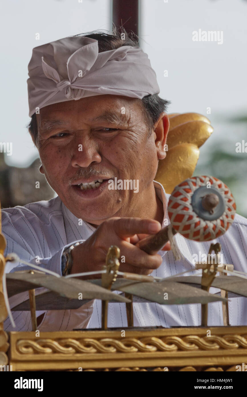 Man playing a metallophone in a gamelan orchestra in Bali Indonesia ...