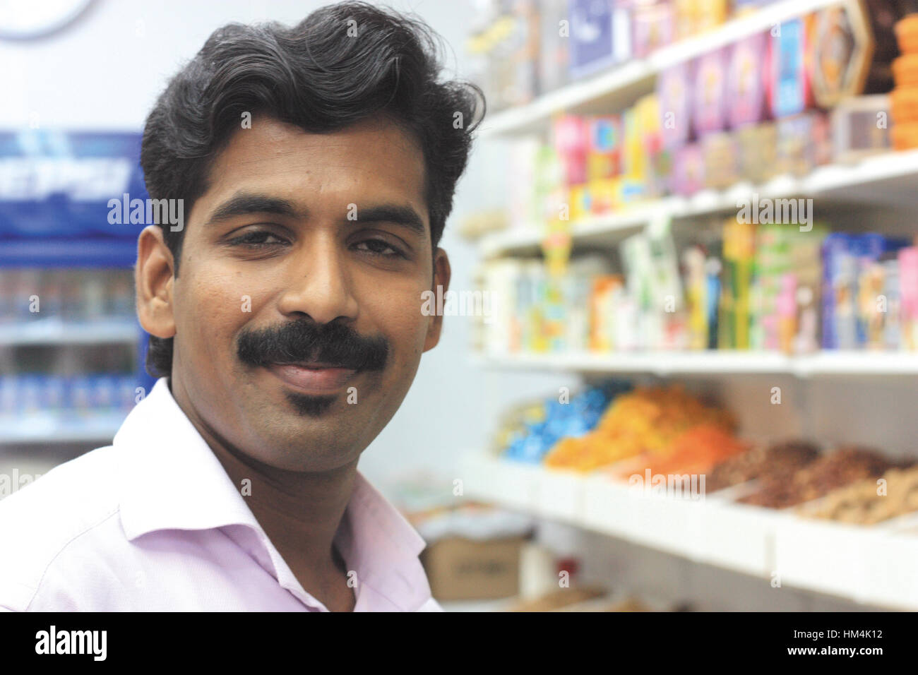 Young man in store Stock Photo - Alamy