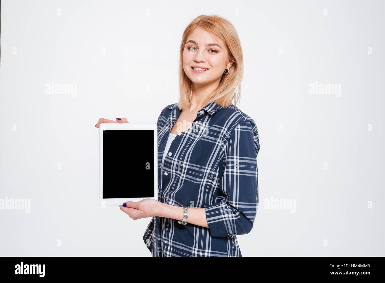 Photo of gorgeous young lady holding tablet computer and showing ...