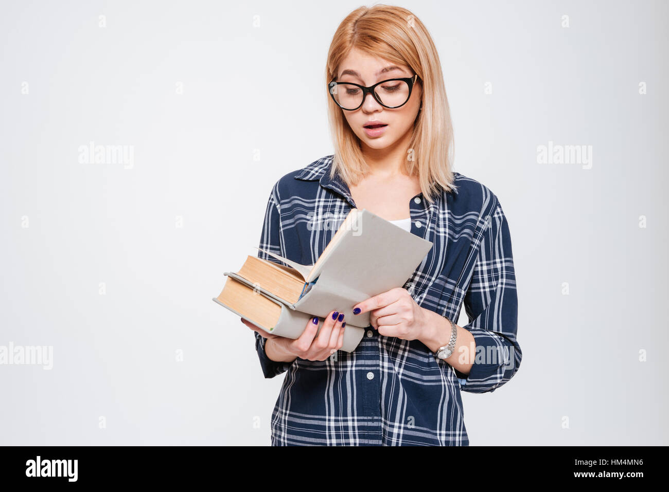 Picture of attractive young lady reading books isolated on a white ...