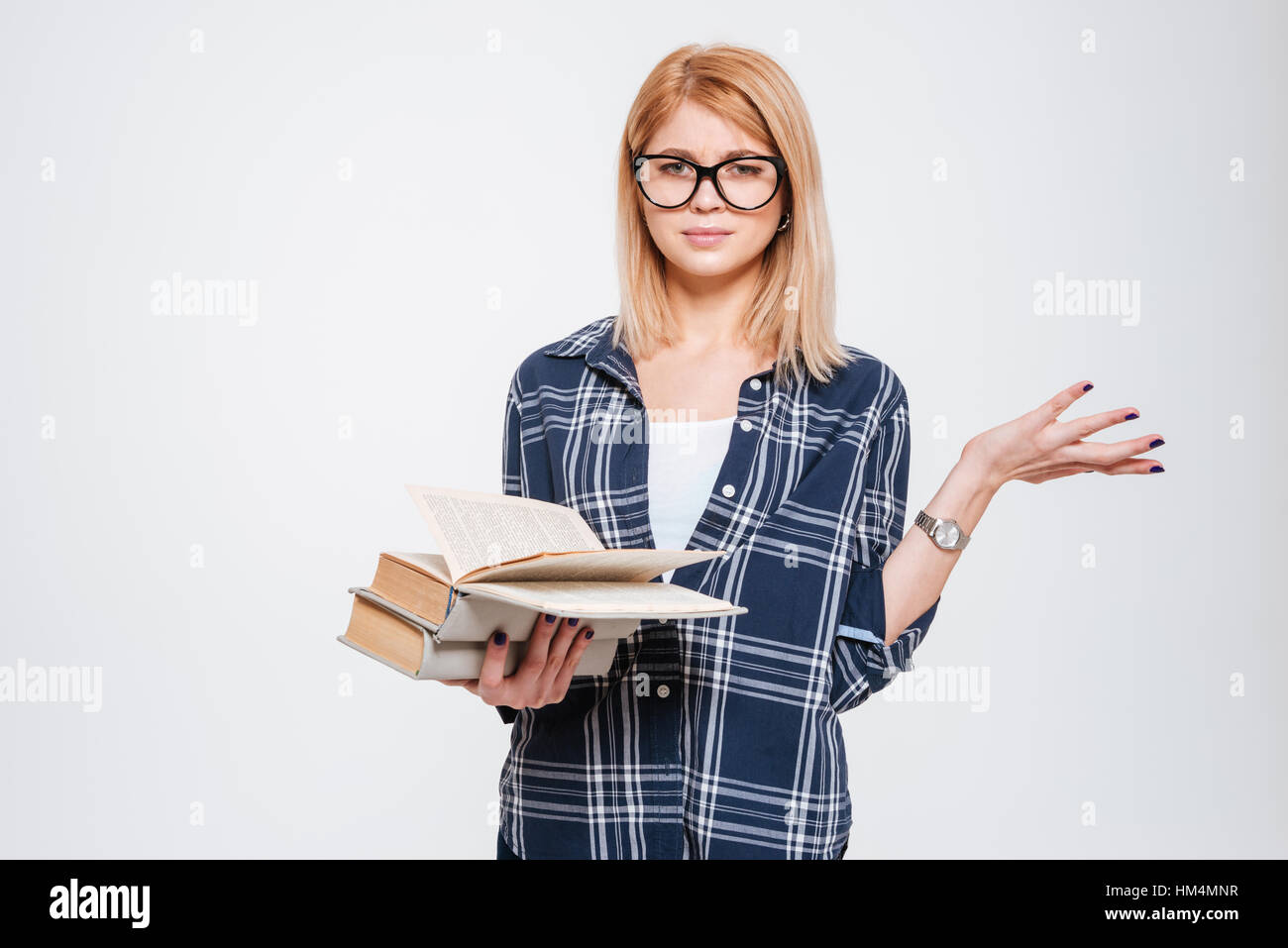 Image of confused young lady reading books isolated on a white ...