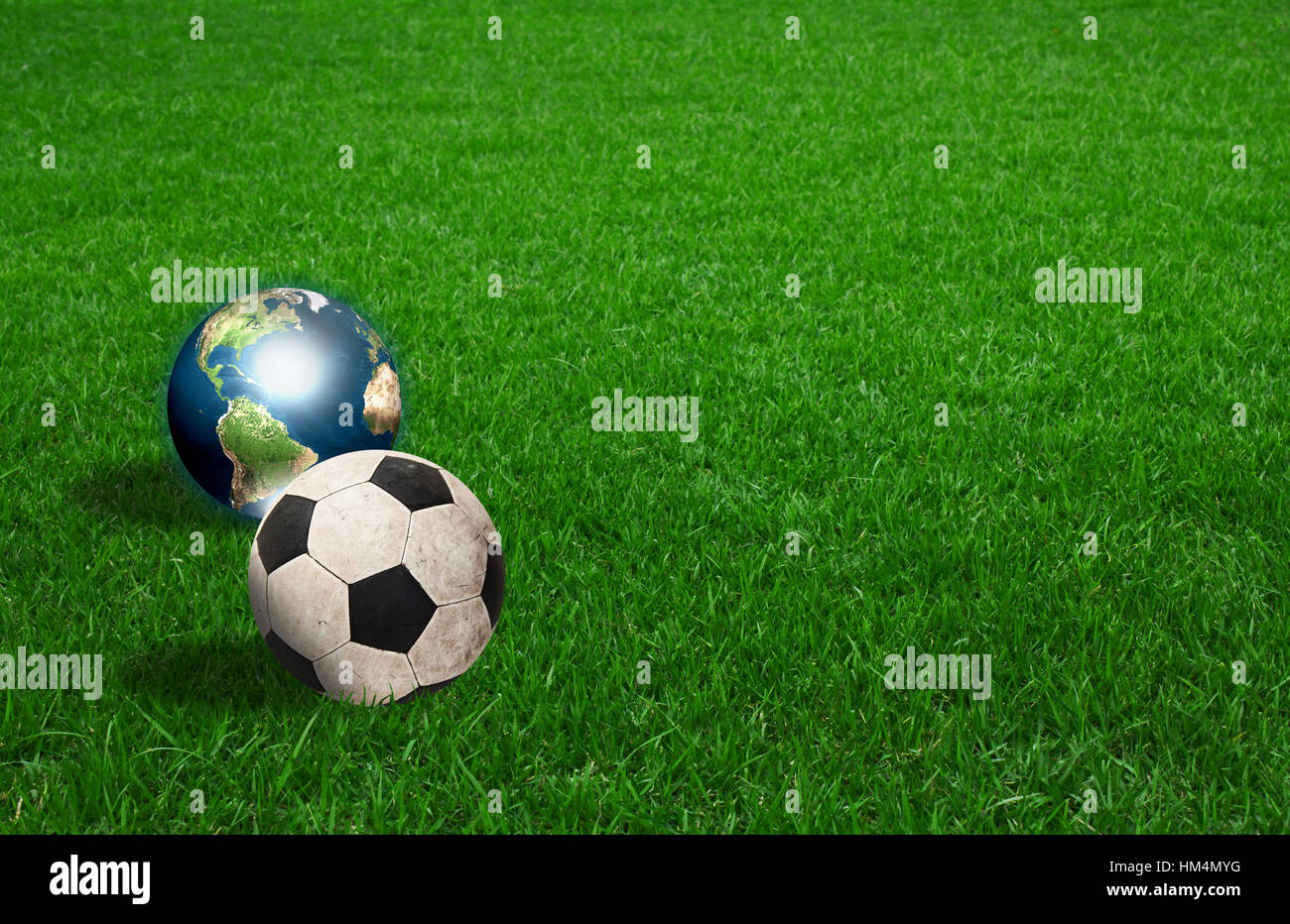 soccer ball and earth on green grass (Elements of this image furnished ...