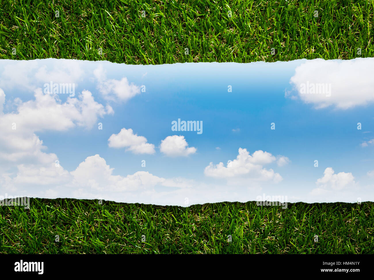 Ripped paper on green grass and blue sky Stock Photo - Alamy