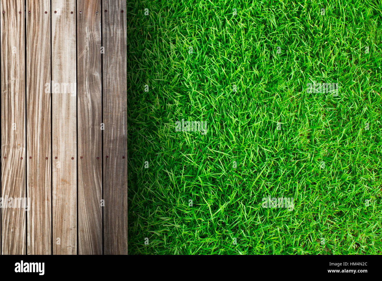 Fresh spring green grass with wood floor Stock Photo - Alamy