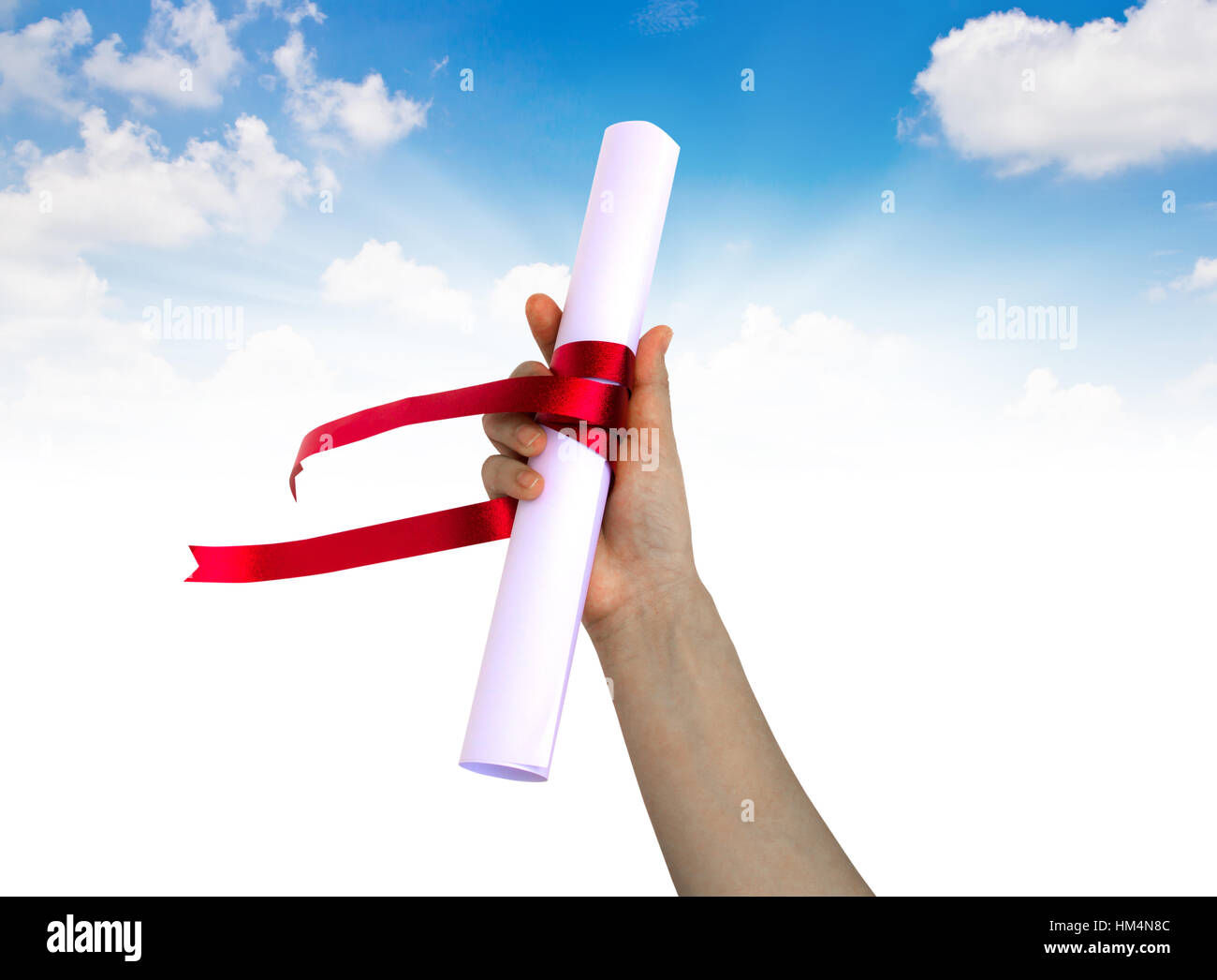 Hand holding Diploma wrapped with a red ribbon Stock Photo - Alamy