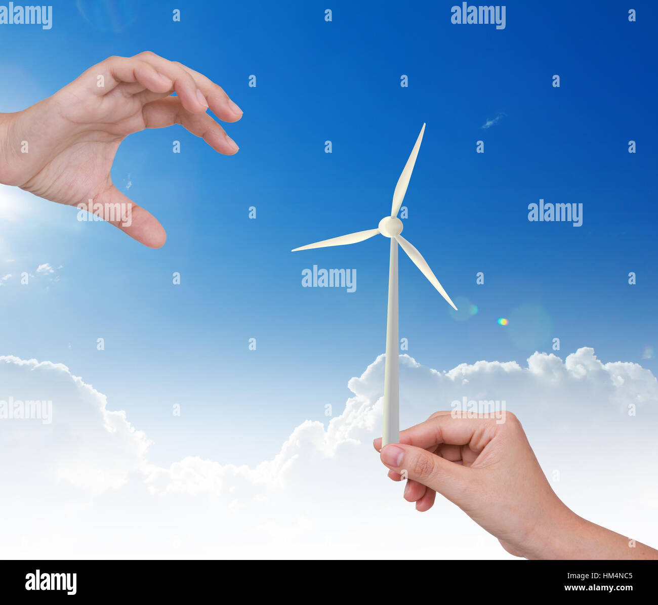 Hand holding Wind Turbine over blue sky Stock Photo - Alamy