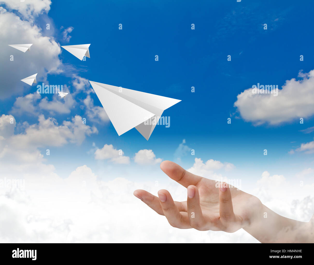Hand throwing a paper plane in the sky Stock Photo - Alamy