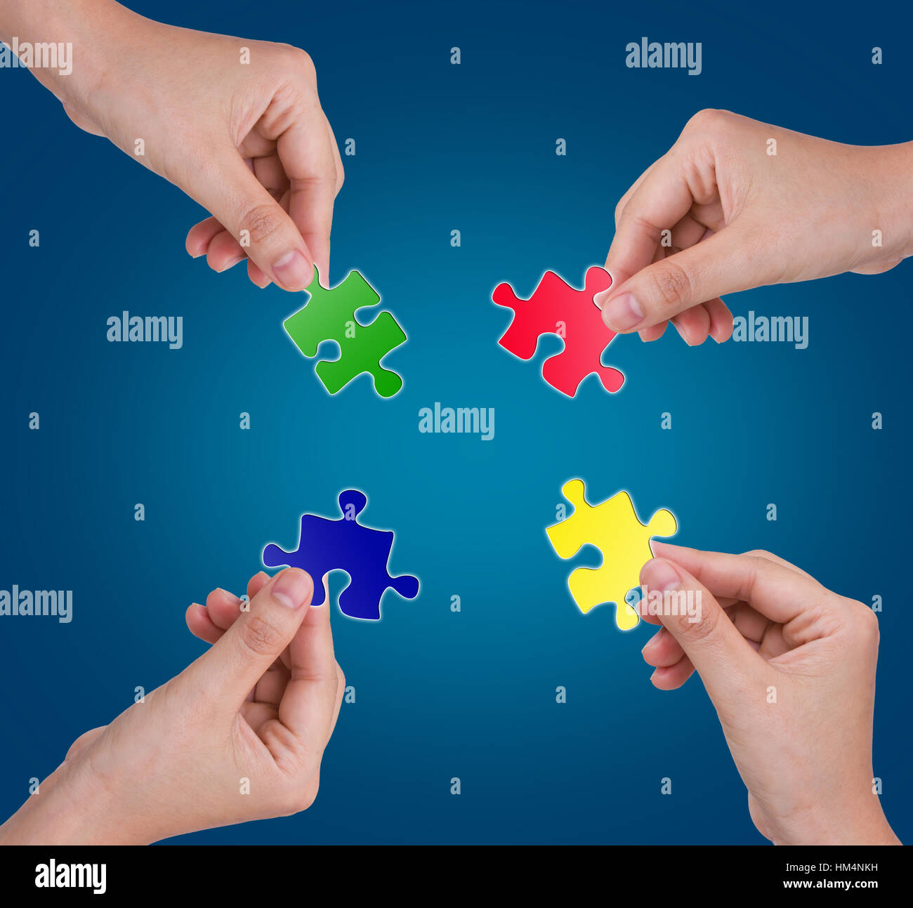 Hands and puzzle Stock Photo - Alamy