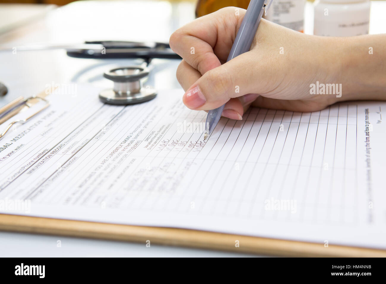 Doctor hand writing a medical recipe Stock Photo - Alamy