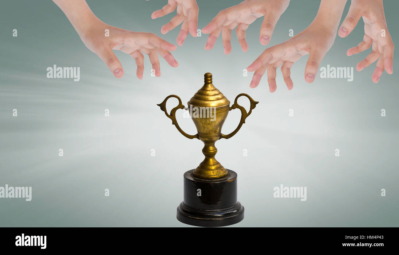 Hands and old golden trophy Stock Photo - Alamy