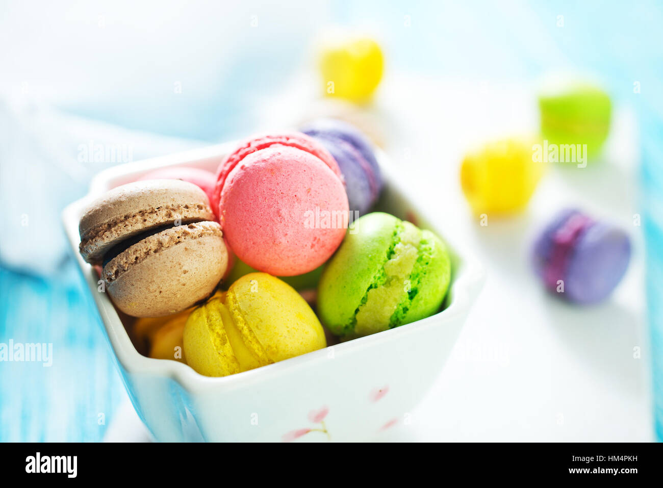 color macaroons in bowl and on a table Stock Photo - Alamy