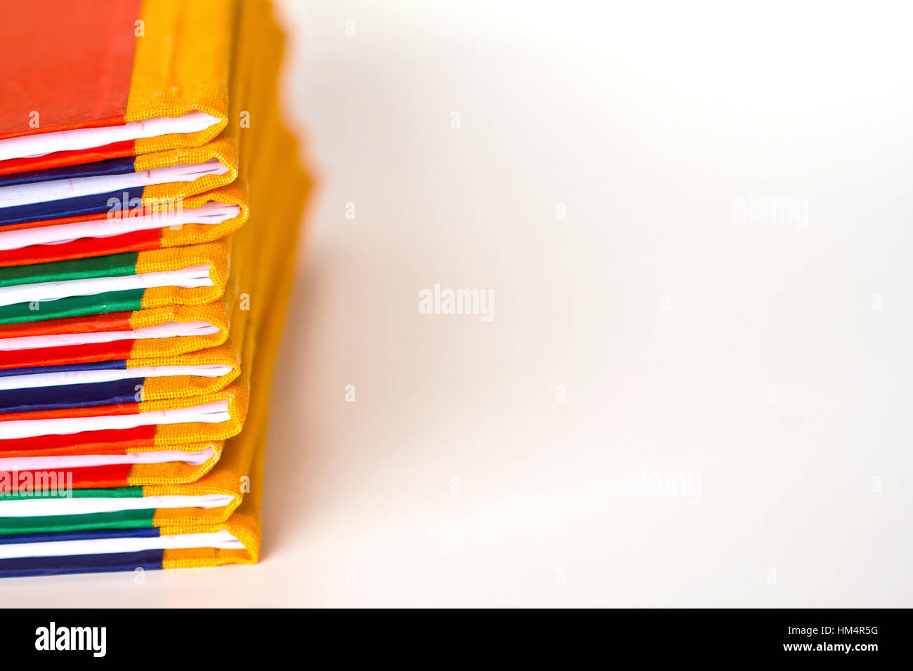 Stack of colorful books on white background, side view Stock Photo - Alamy