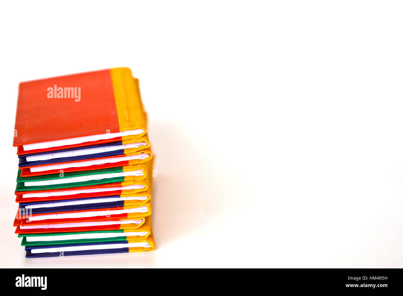 Stack of colorful books on white background, side view Stock Photo - Alamy