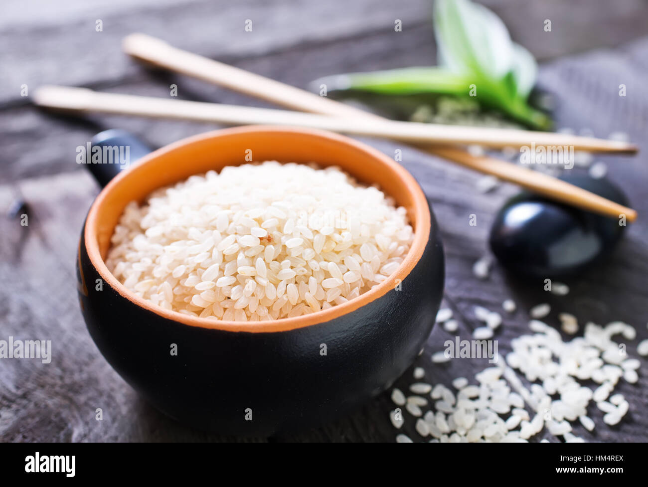 raw rice in bowl and on a table Stock Photo - Alamy