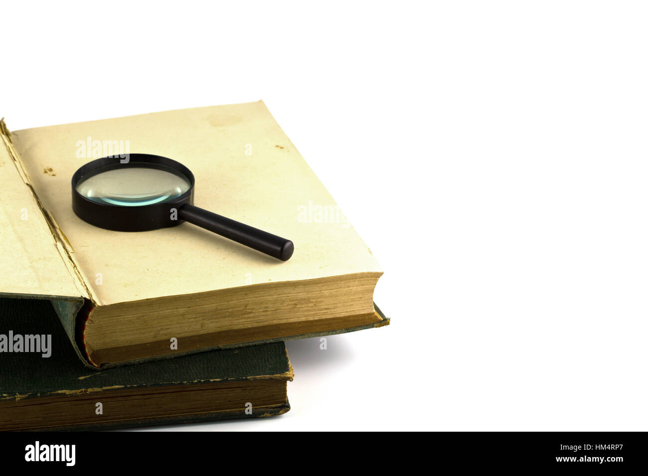 Old book and magnifying glass Stock Photo - Alamy