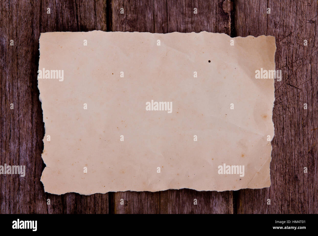 Old paper on brown wood Stock Photo - Alamy