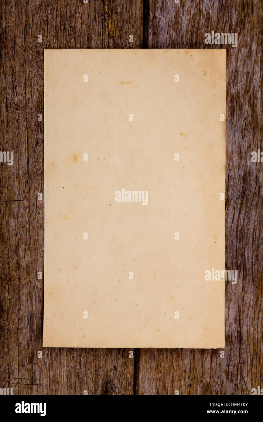 Old paper on brown wood Stock Photo - Alamy