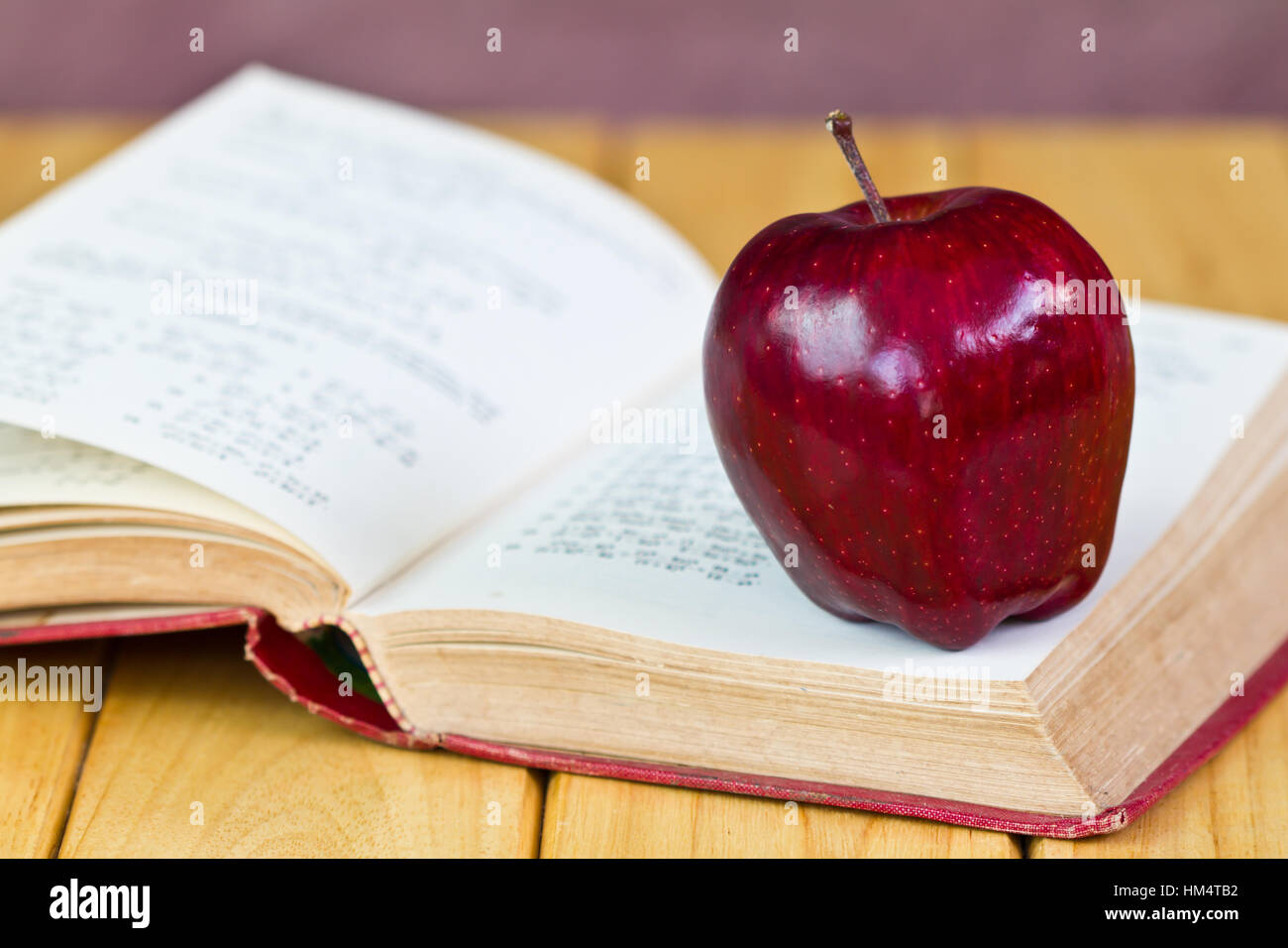 Stack of books with a red apple Stock Photo - Alamy