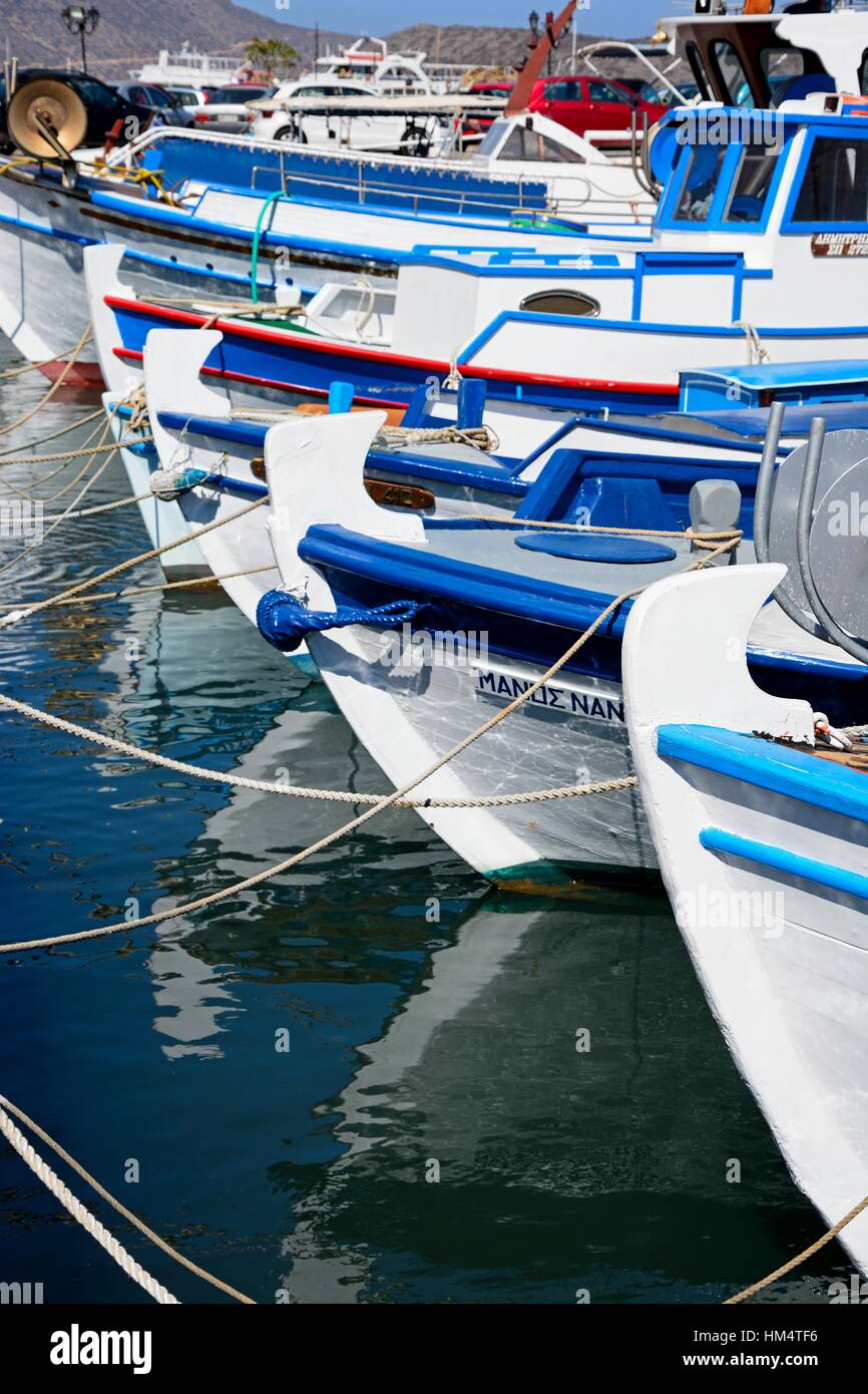 Traditional Greek fishing boats moored in the harbour, Elounda, Crete ...