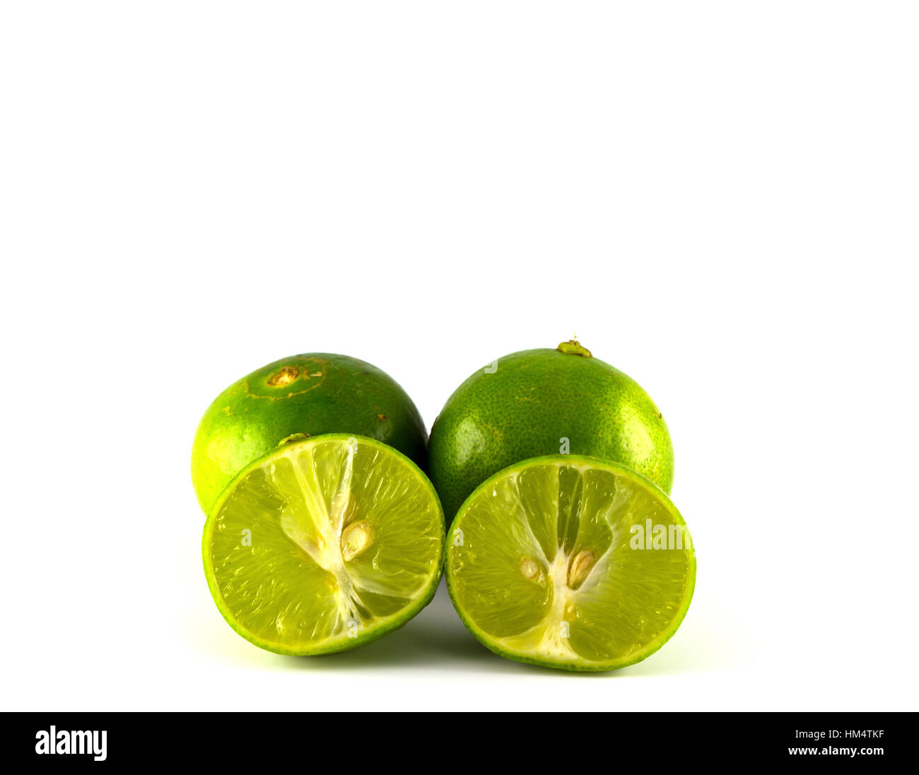 Green lemons and fresh ripe lemon isolated on white background Stock ...