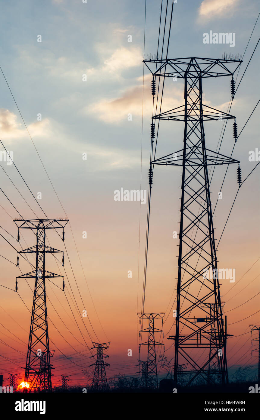 Electricity pylons and power lines, at sunset Stock Photo - Alamy