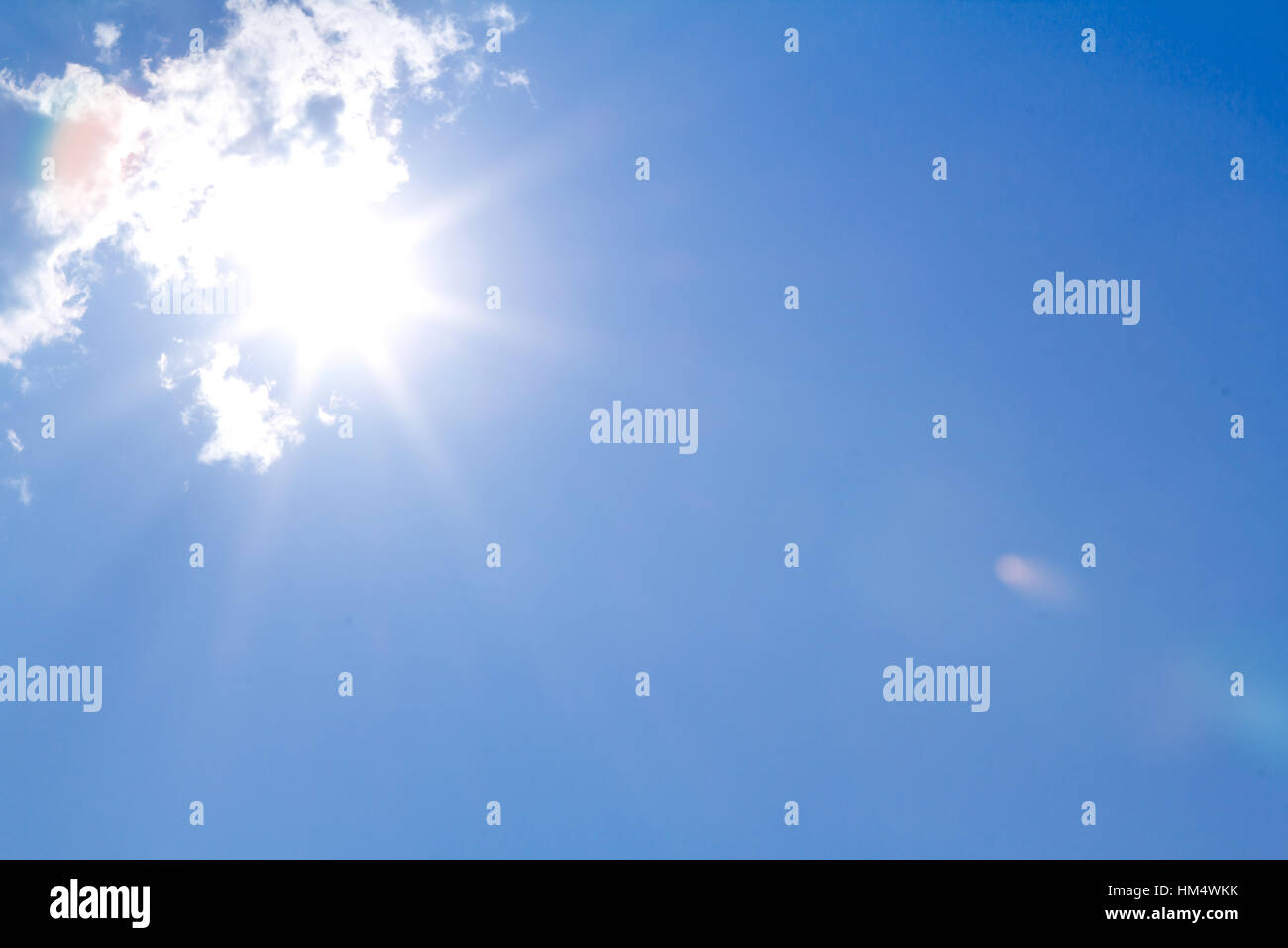 Blue sky with sun and beautiful clouds Stock Photo - Alamy