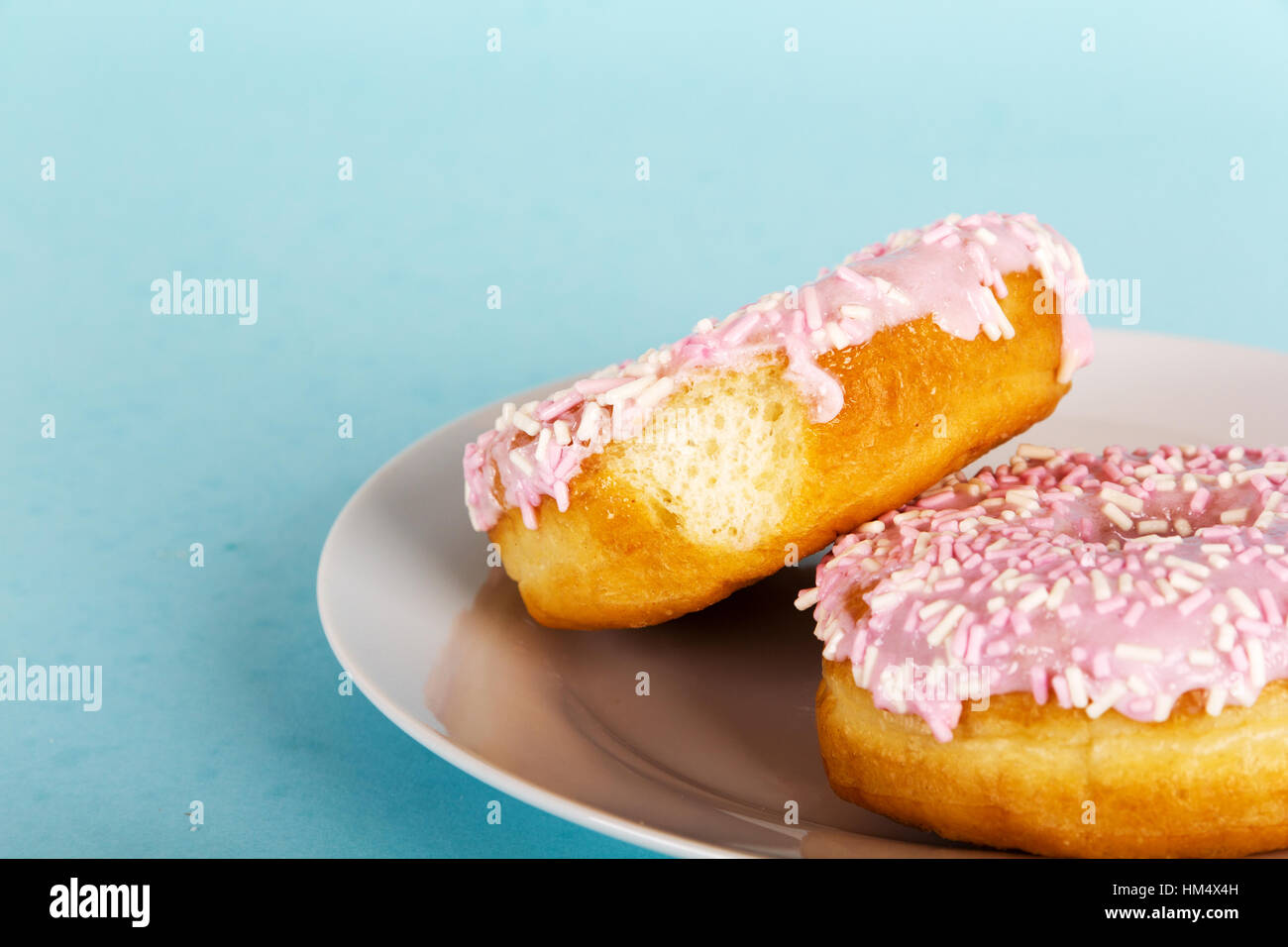 Iced doughnut on a light coloured blue background Stock Photo - Alamy