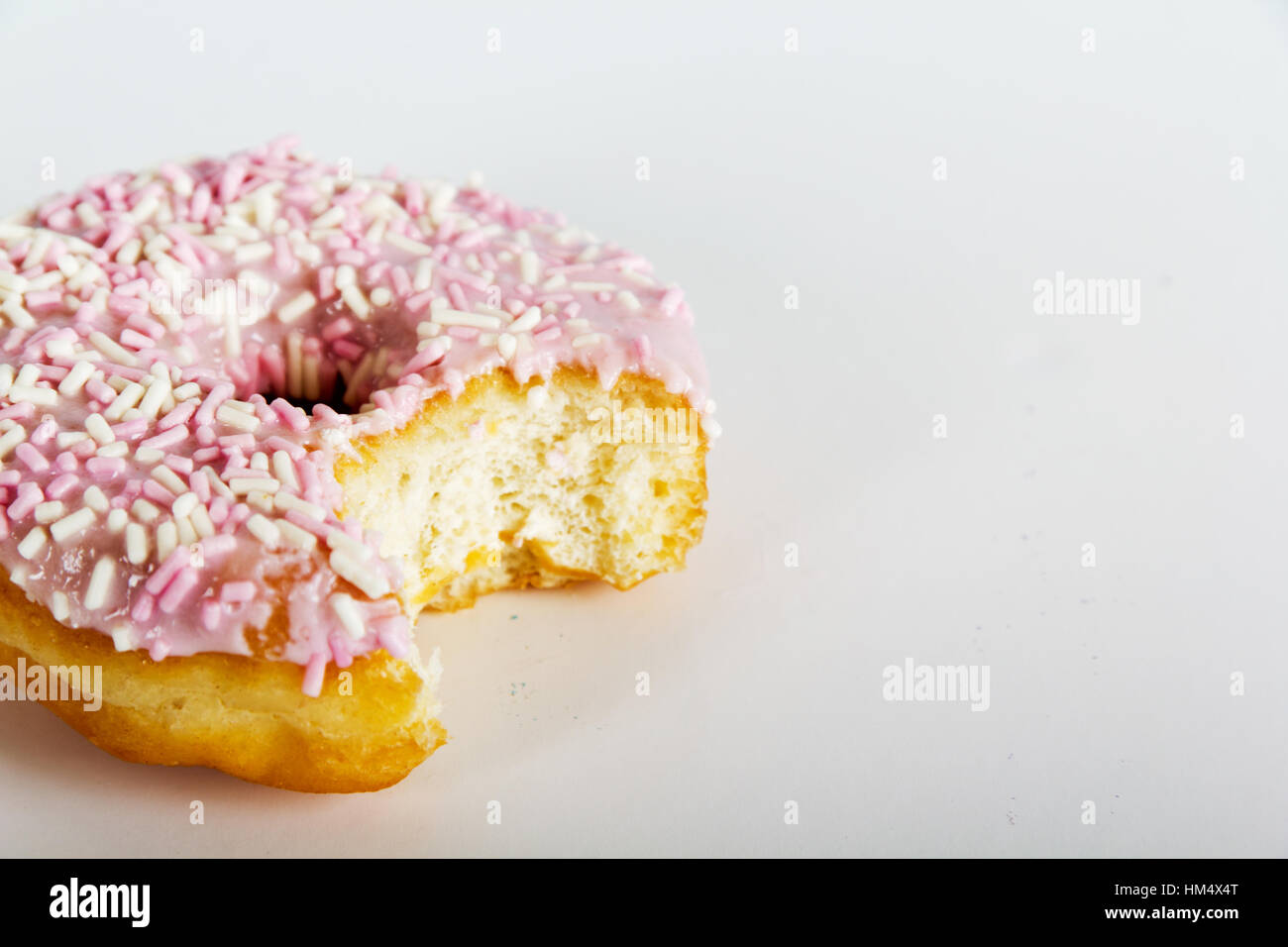 Iced doughnut on a light coloured background Stock Photo - Alamy