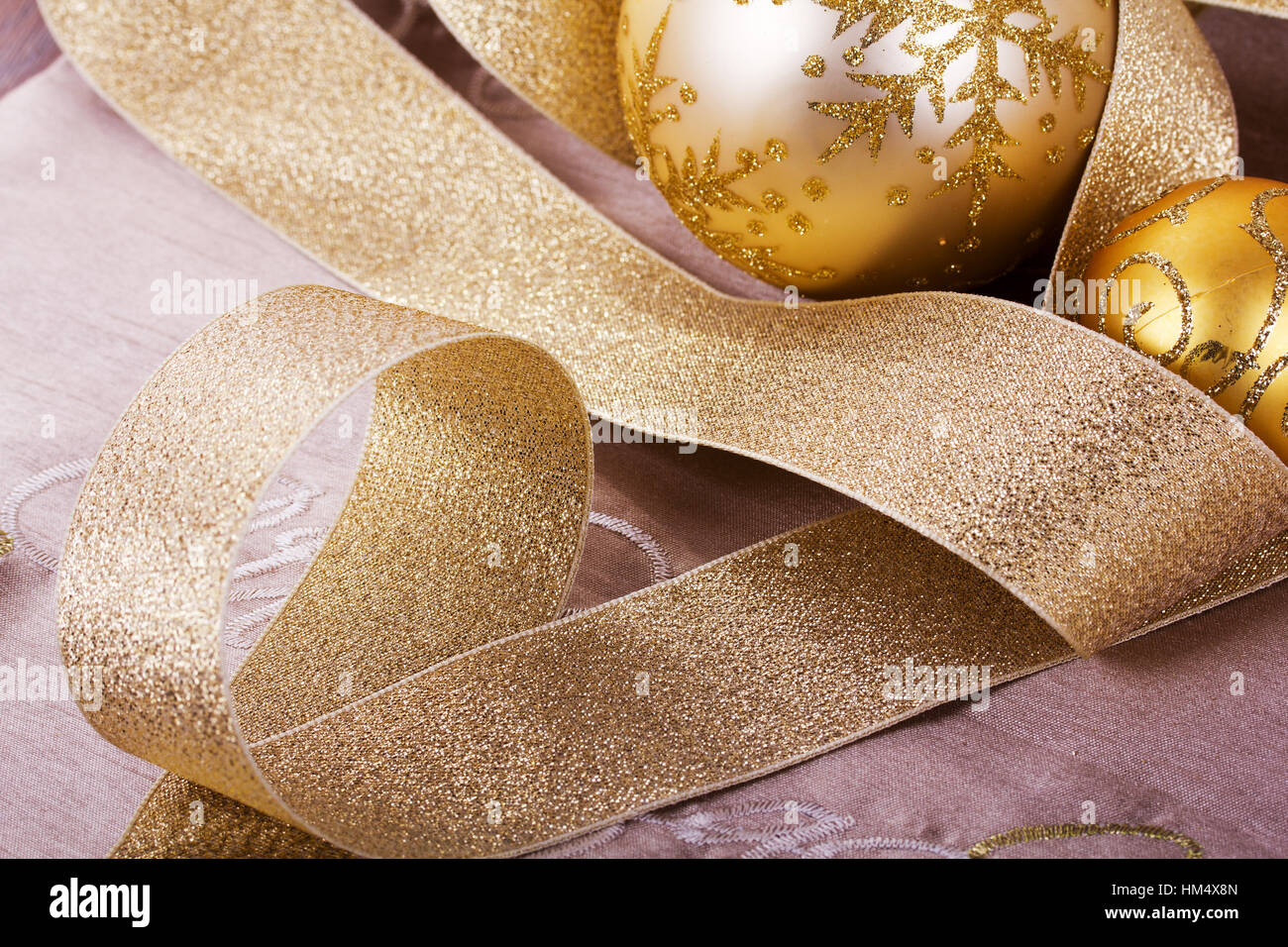Festive gold Christmas decorations on a fabric background Stock Photo ...