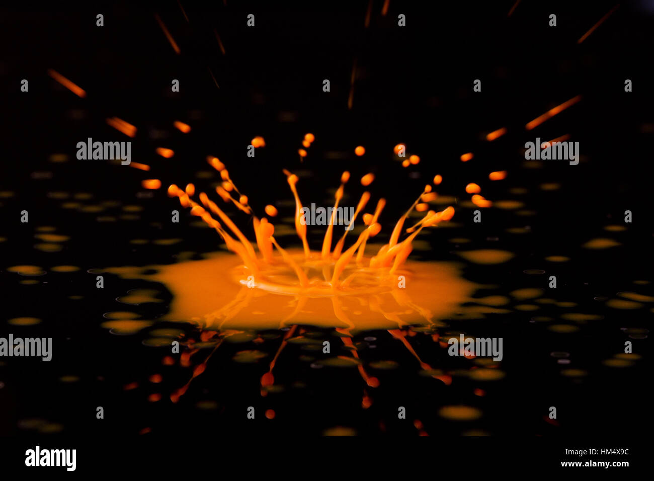 Colorful paint drop splashing on black a background Stock Photo - Alamy