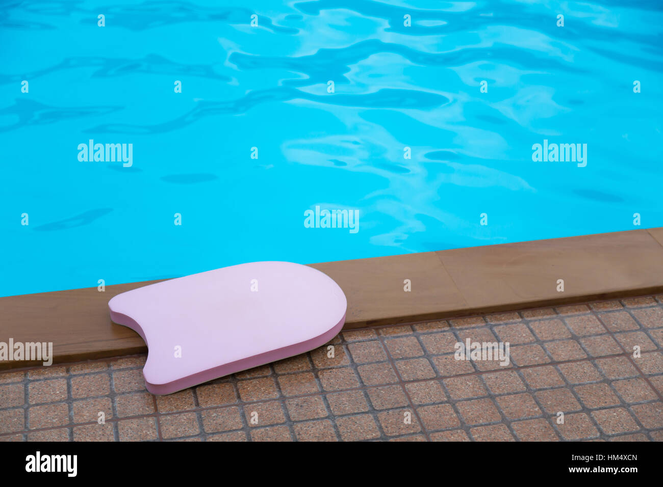 Pink boogie board in swimming pool Stock Photo - Alamy