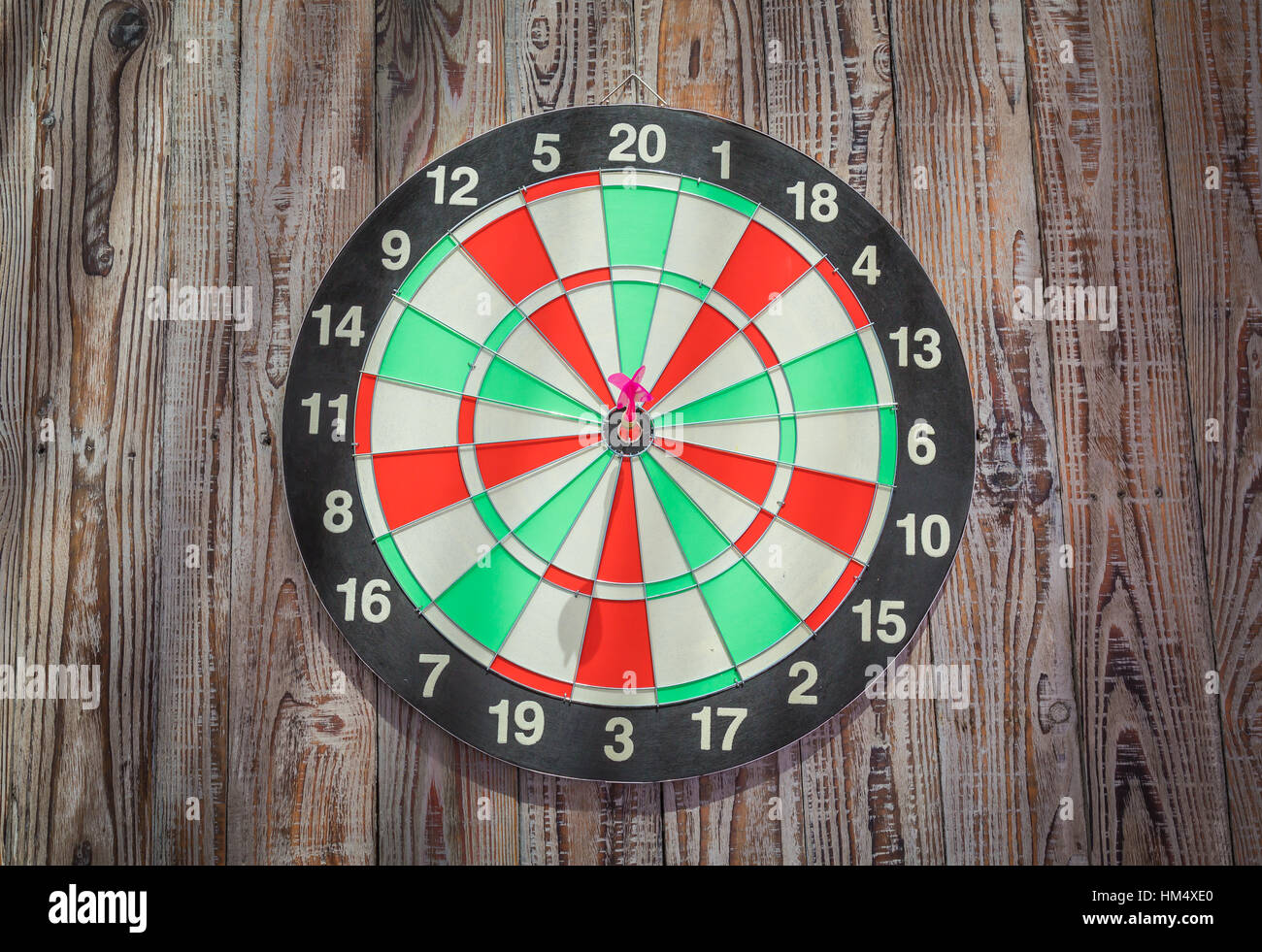 Dartboard on wood wall (Darts Hit Target Stock Photo - Alamy