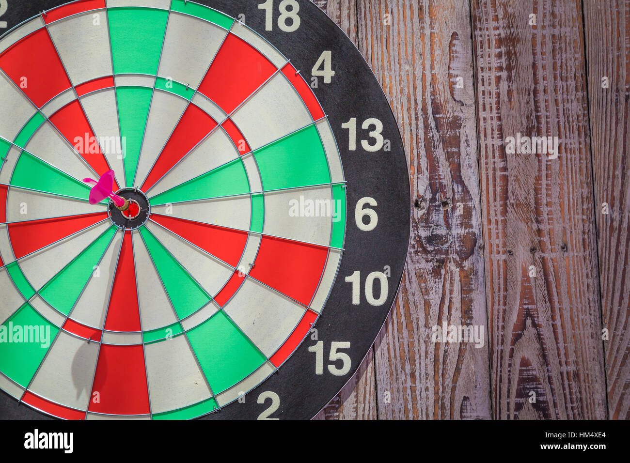 Dartboard on wood wall (Darts Hit Target Stock Photo - Alamy