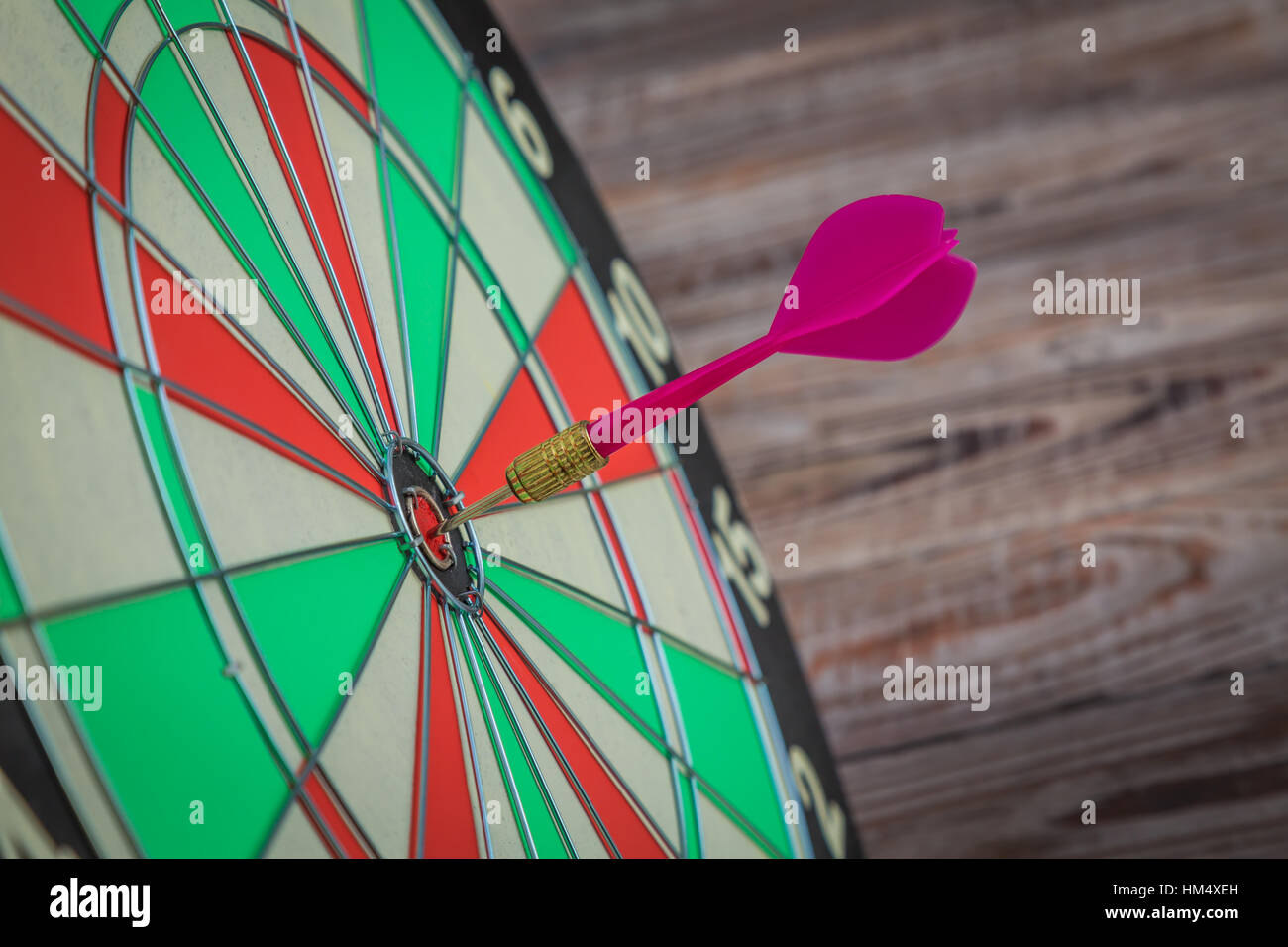 Dartboard on wood wall (Darts Hit Target Stock Photo - Alamy