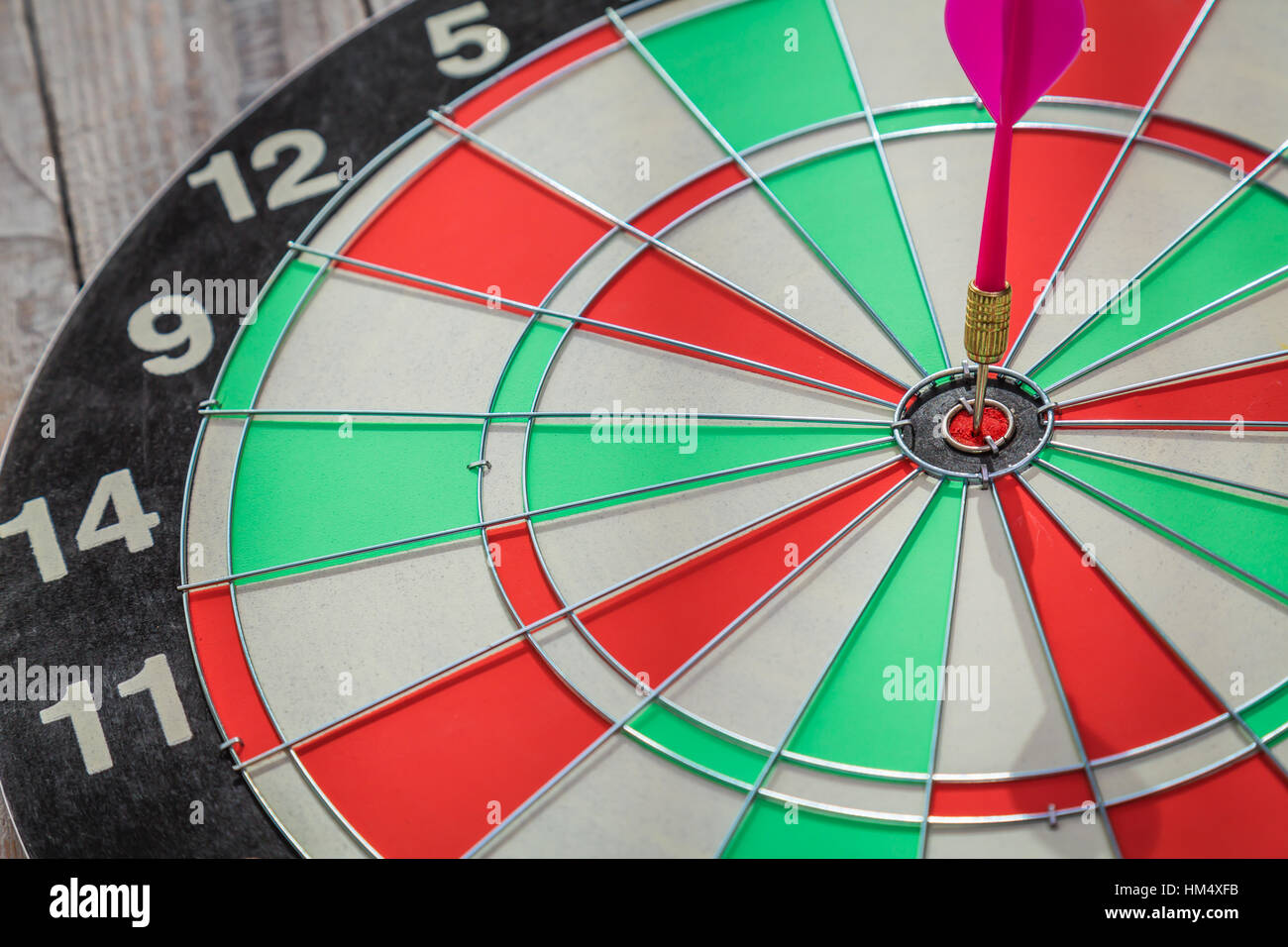 Dartboard on wood wall (Darts Hit Target Stock Photo - Alamy