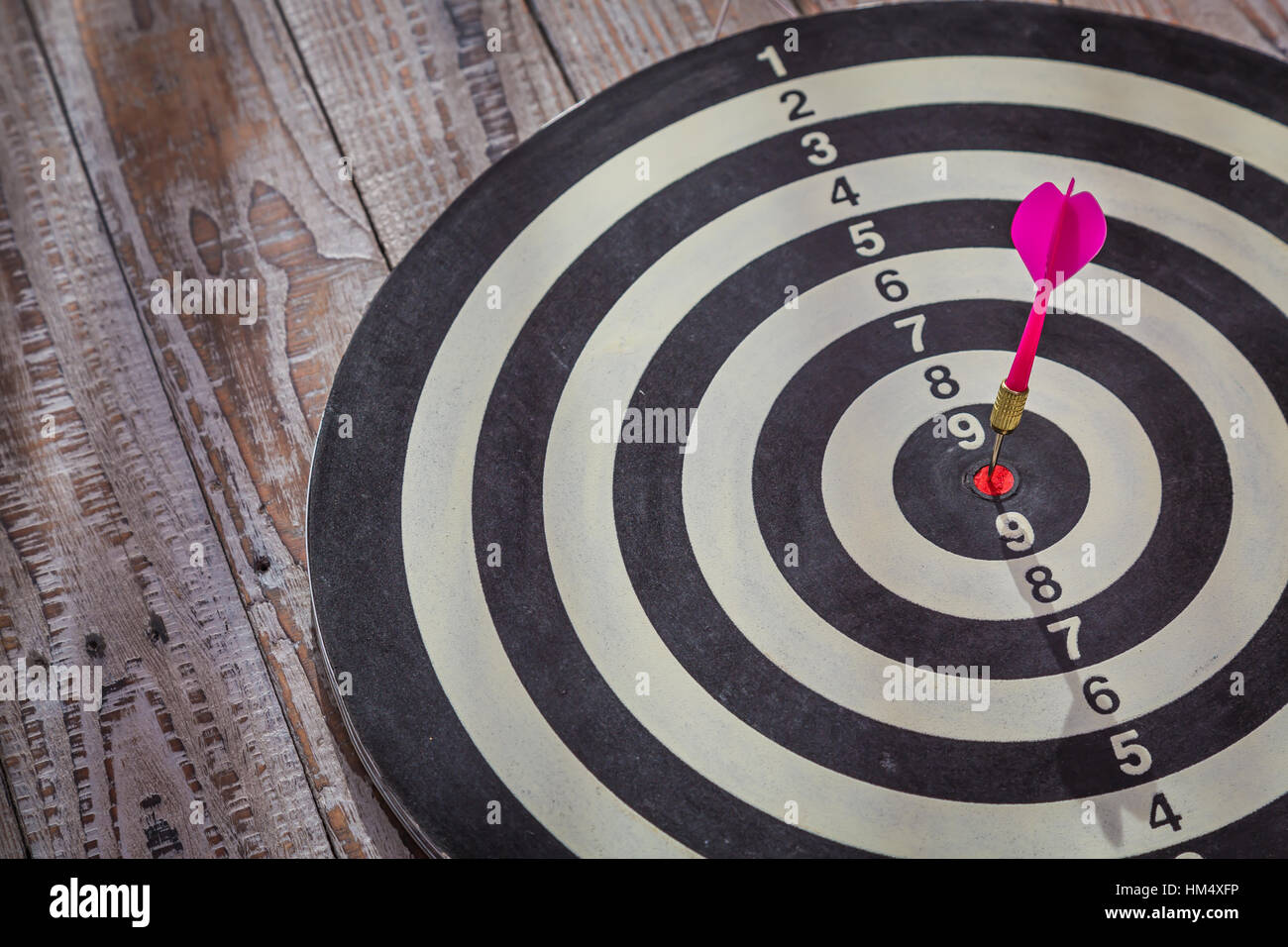 Dartboard on wood wall (Darts Hit Target Stock Photo - Alamy