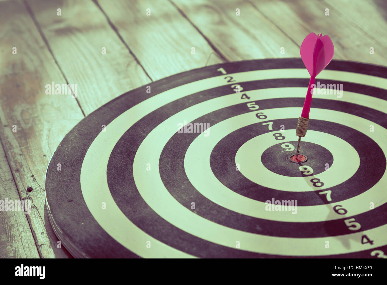 Dartboard on wood wall (Darts Hit Target Stock Photo - Alamy