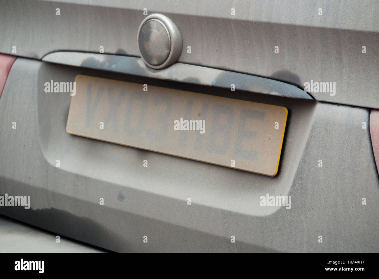 A dirty partially obscure / obscured registration number plate on a car ...