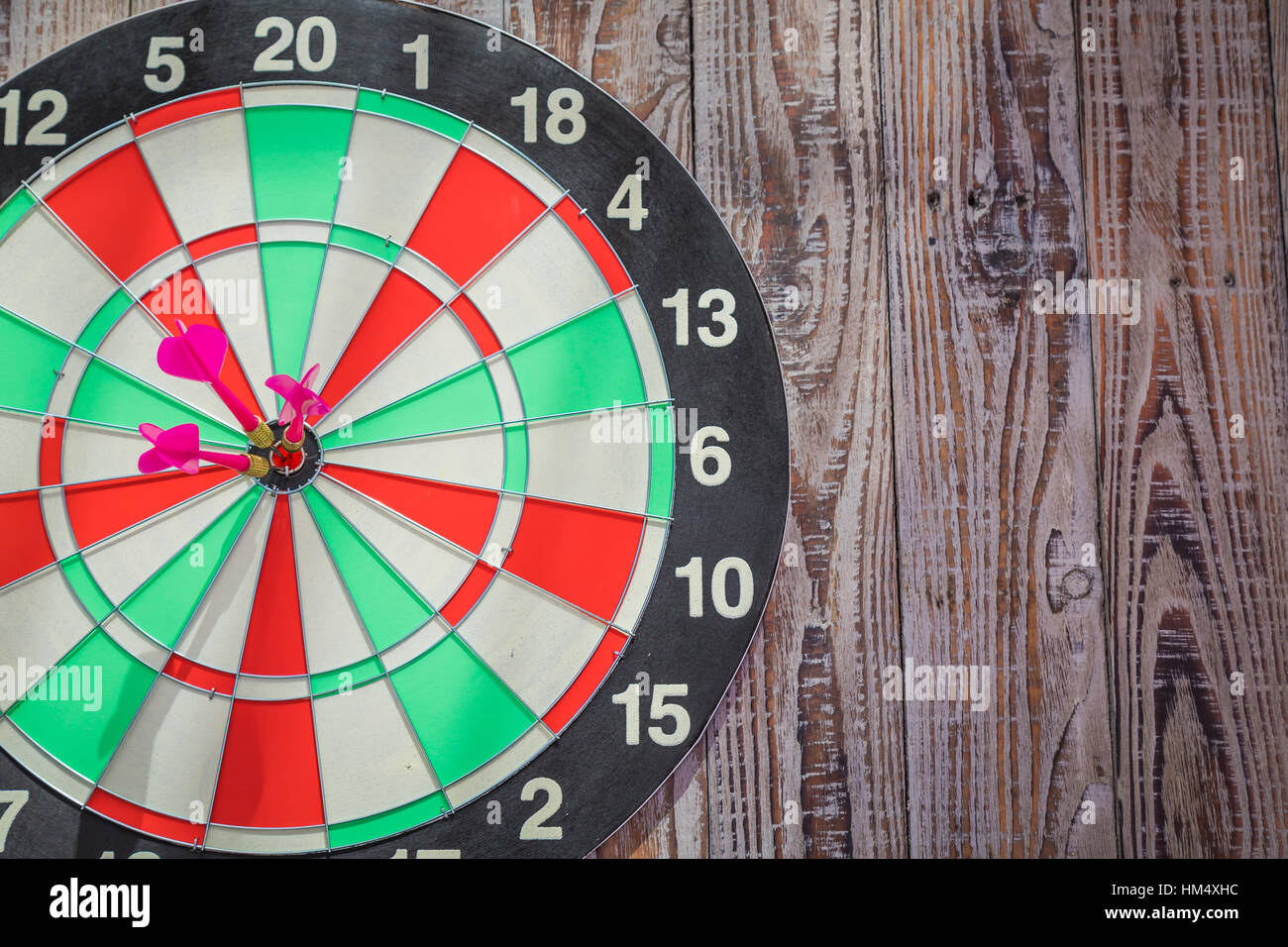 Dartboard on wood wall (Darts Hit Target Stock Photo - Alamy
