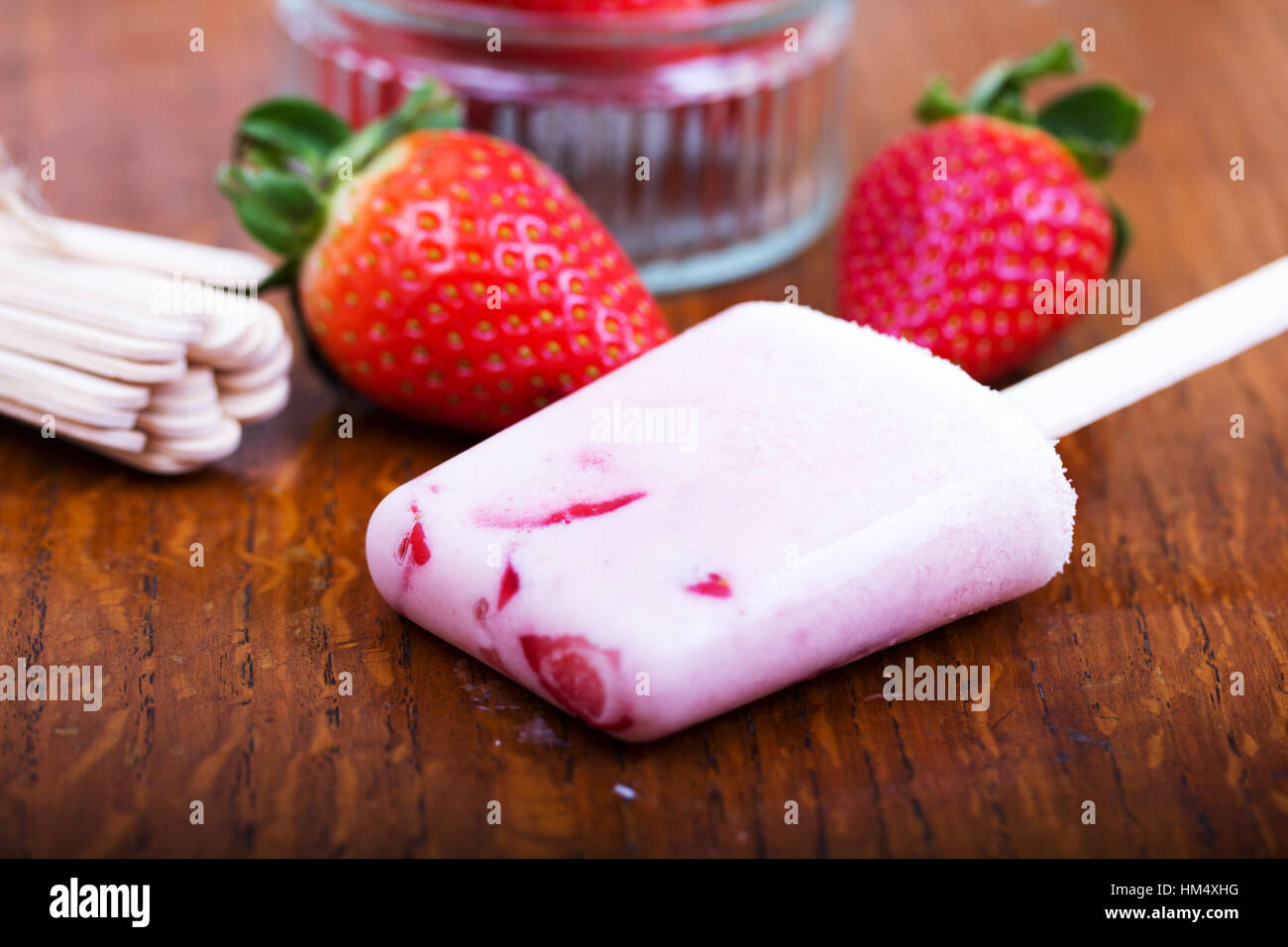 Homemade strawberry ice lolly on a rustic background Stock Photo - Alamy