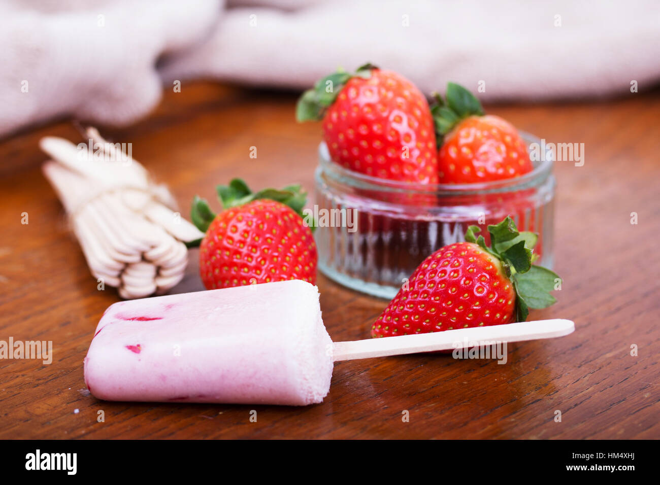 Homemade strawberry ice lolly on a rustic background Stock Photo - Alamy