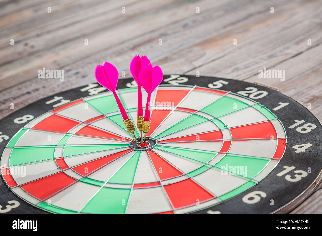 Dartboard on wood wall (Darts Hit Target Stock Photo - Alamy