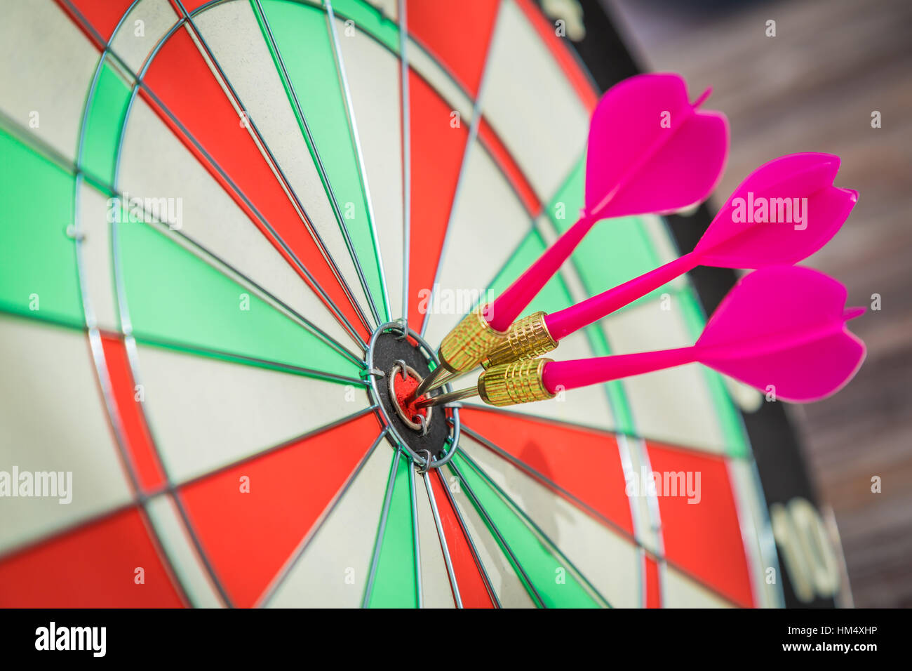 Dartboard on wood wall (Darts Hit Target Stock Photo - Alamy