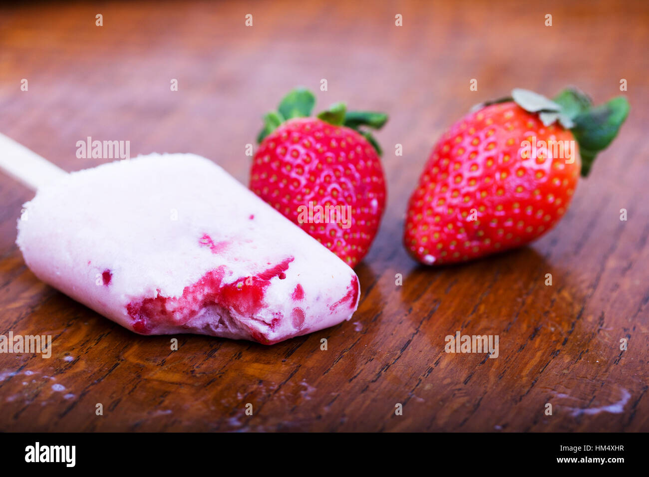 Homemade strawberry ice lolly on a rustic background Stock Photo - Alamy