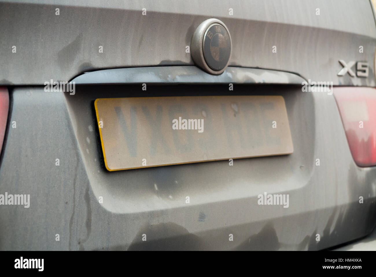 A dirty partially obscure / obscured registration number plate on a car ...