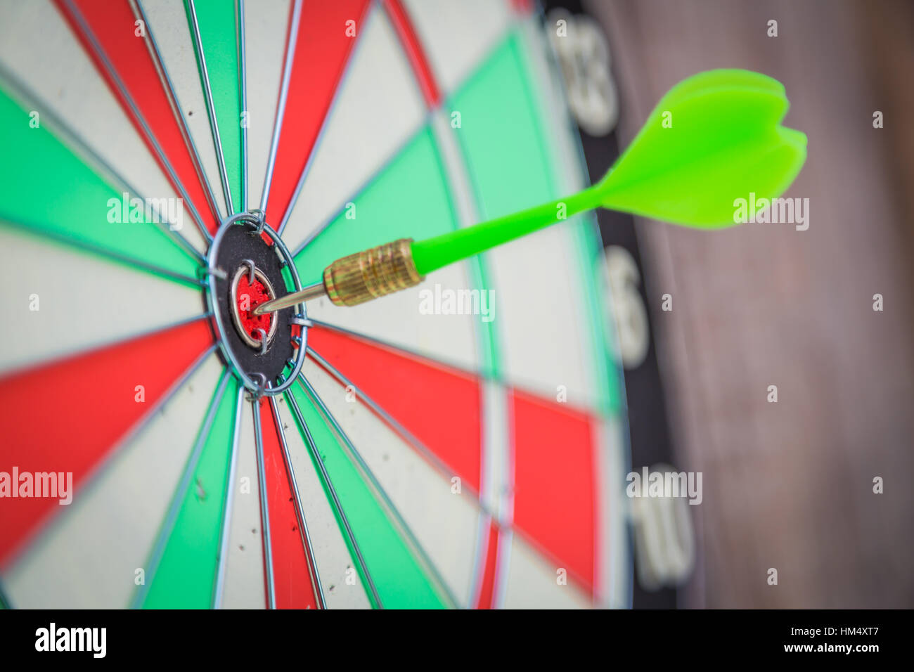 Dartboard on wood wall (Darts Hit Target Stock Photo - Alamy