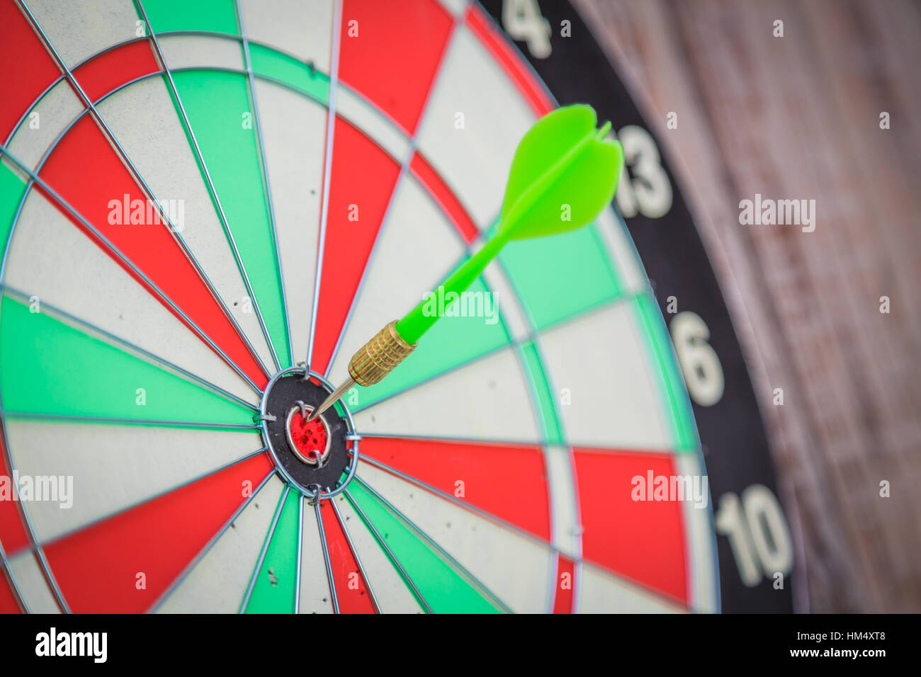 Dartboard on wood wall (Darts Hit Target Stock Photo - Alamy