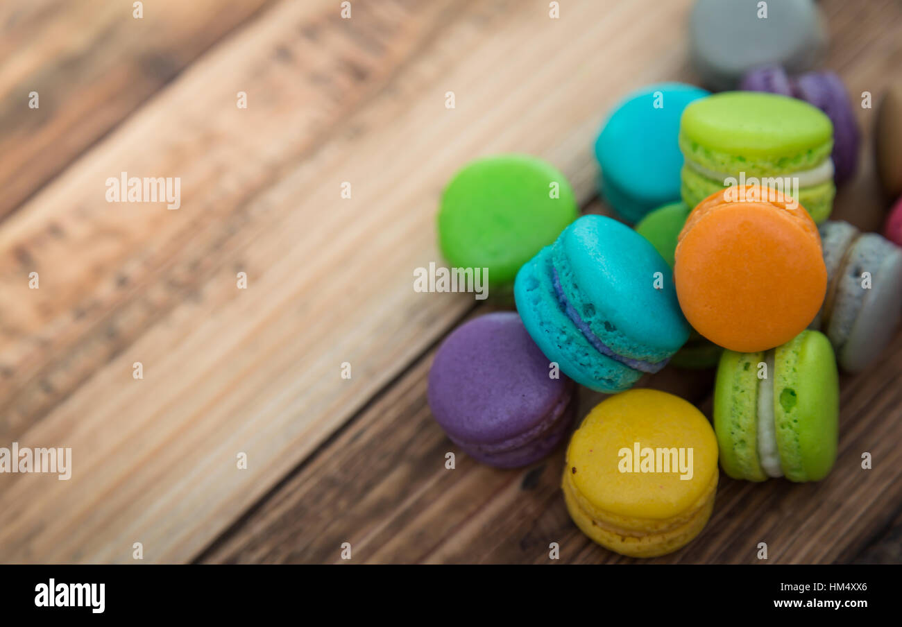 French colorful macarons on wood table Stock Photo - Alamy