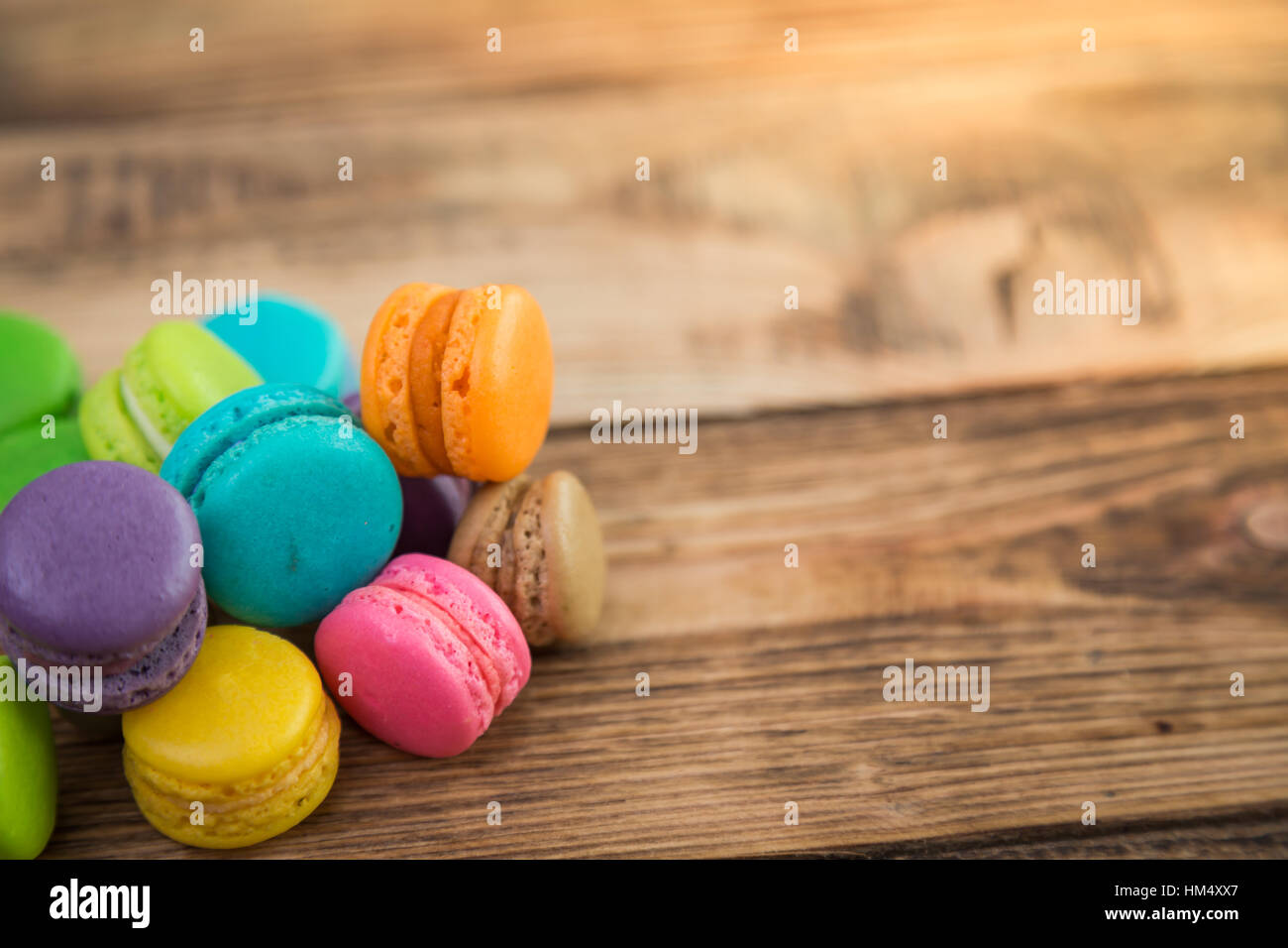 French colorful macarons on wood table Stock Photo - Alamy